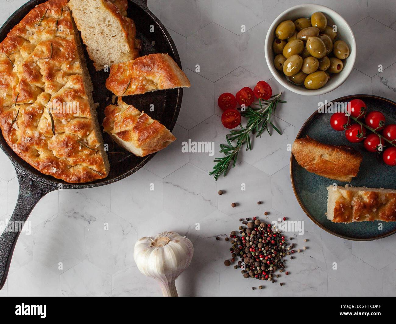 Top view of focaccia Italian bread with olive , tomato , garlic ...