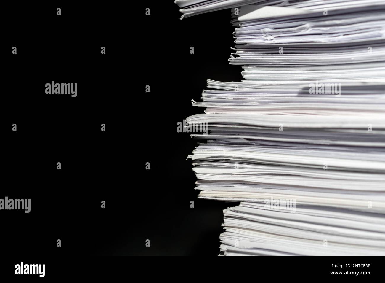 Pile of paper documents on a black background Stock Photo - Alamy