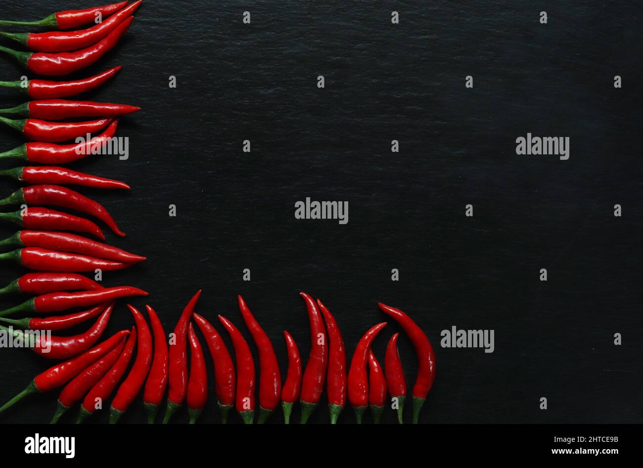 Shot of red hot peppers on slate background for restaurant menu Stock ...