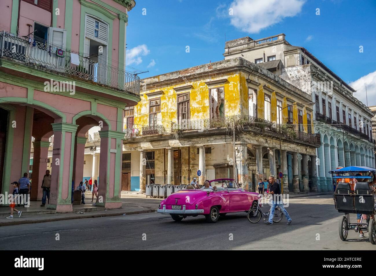 Beautiful shot of vintage colorful cars driving around in old Havana ...