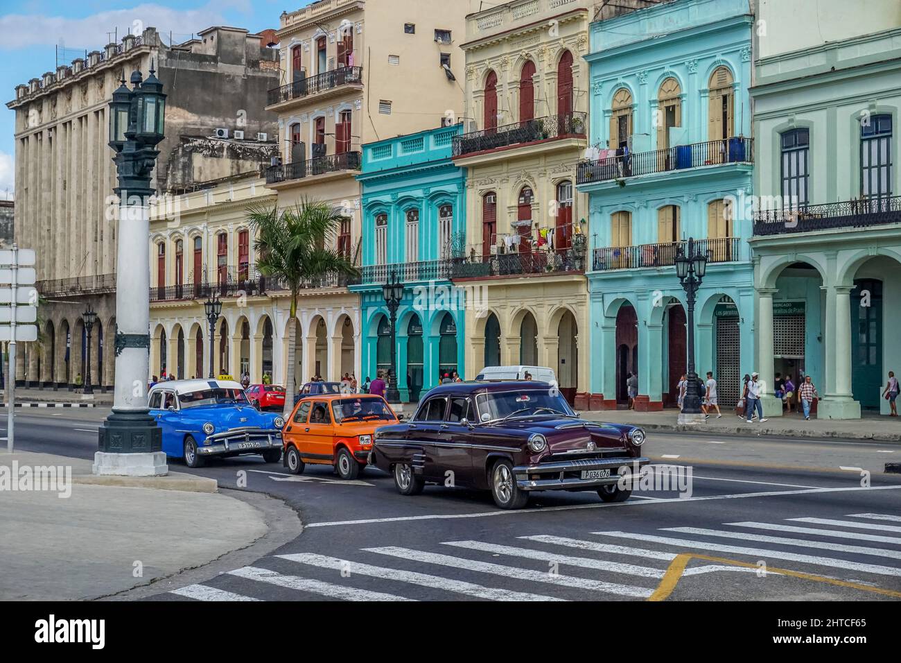 Beautiful shot of vintage colorful cars driving around in old Havana ...