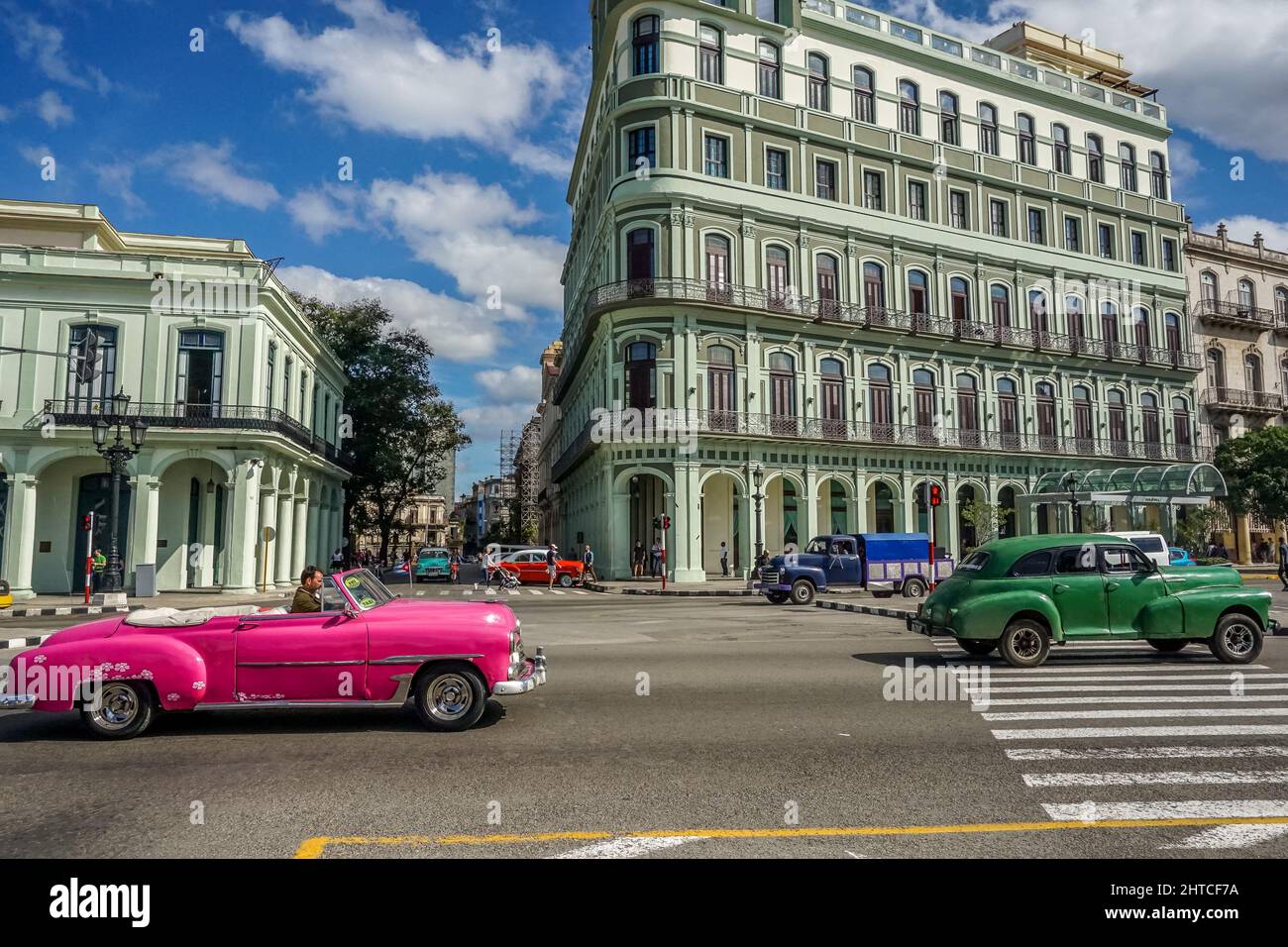 Beautiful shot of vintage colorful cars driving around in old Havana ...