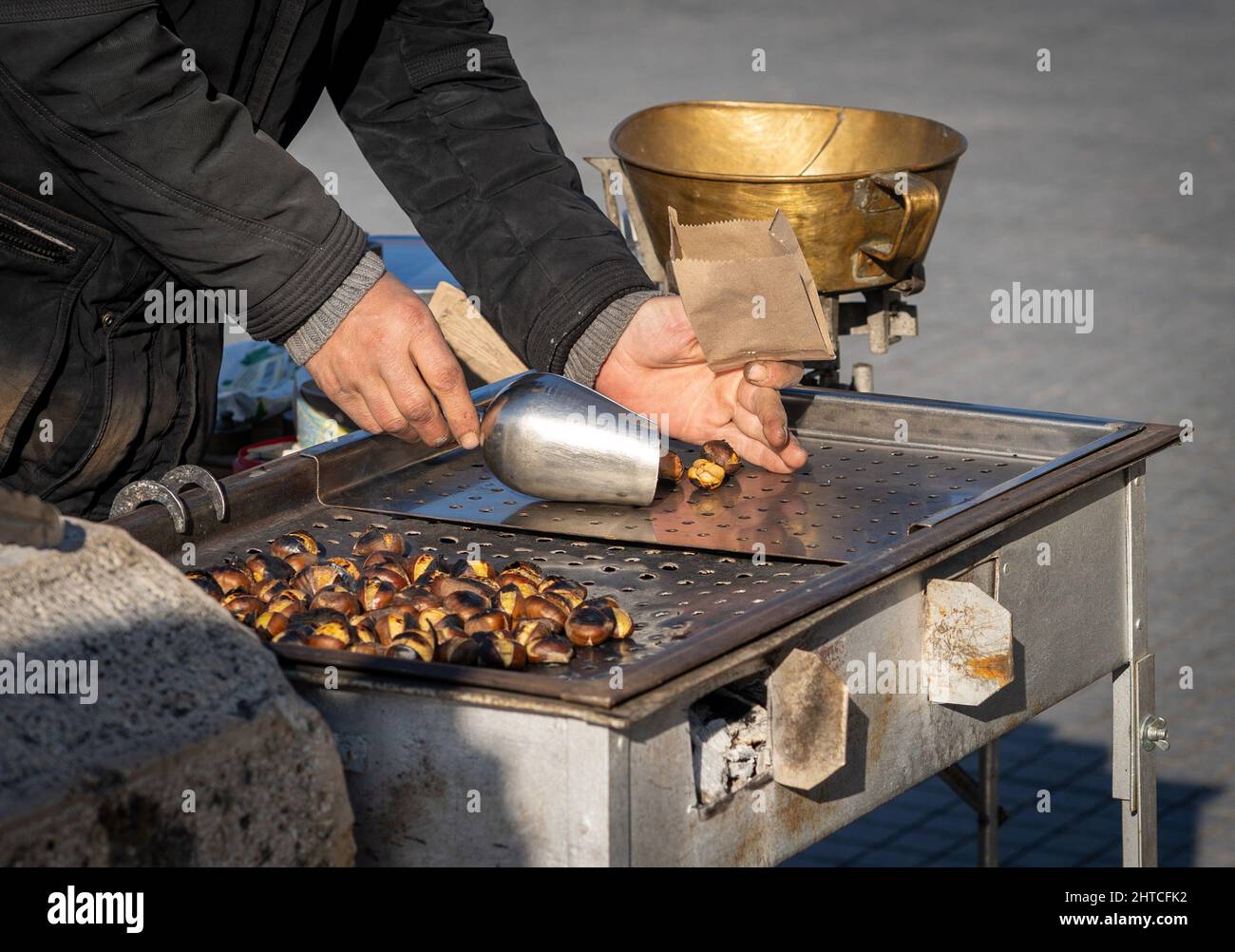 Chestnut salesman packing some of them for sale on the street Stock ...