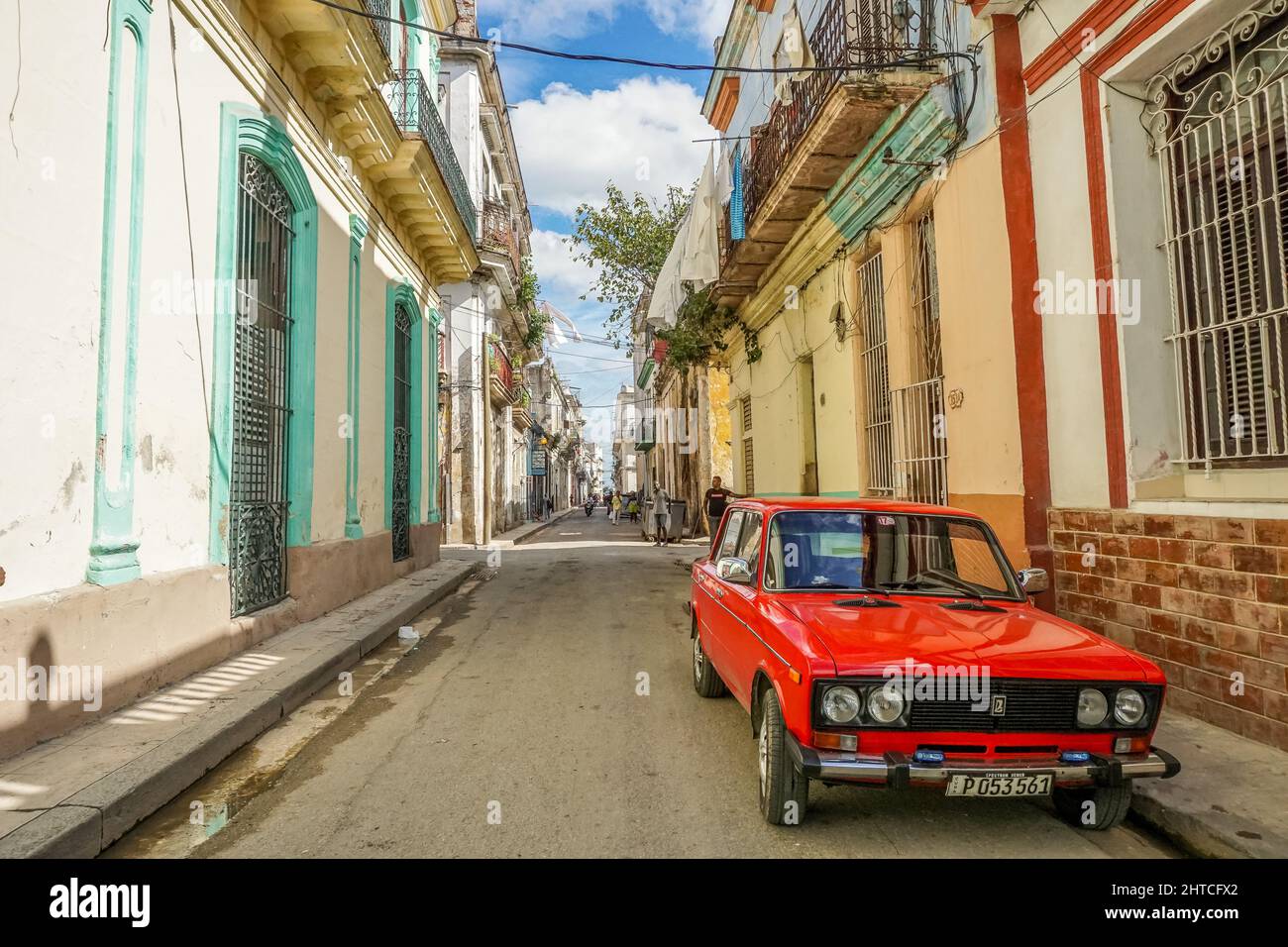 Vanishing point shot of an old alley with a parked rec classic car in ...