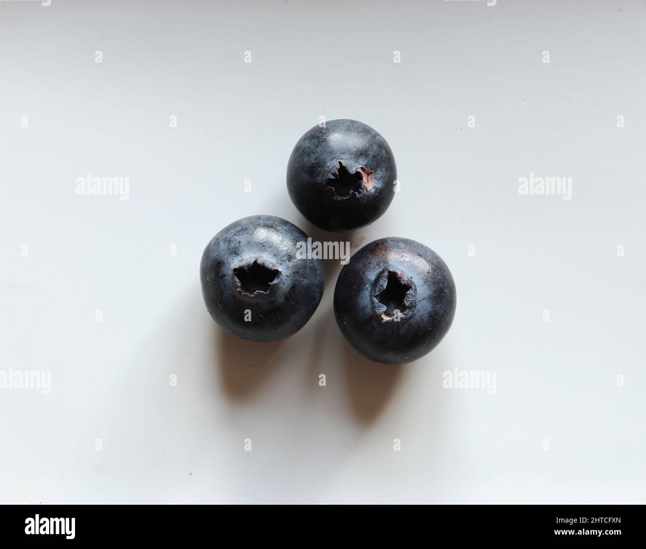 Top view of three blueberries isolated on white background Stock Photo ...