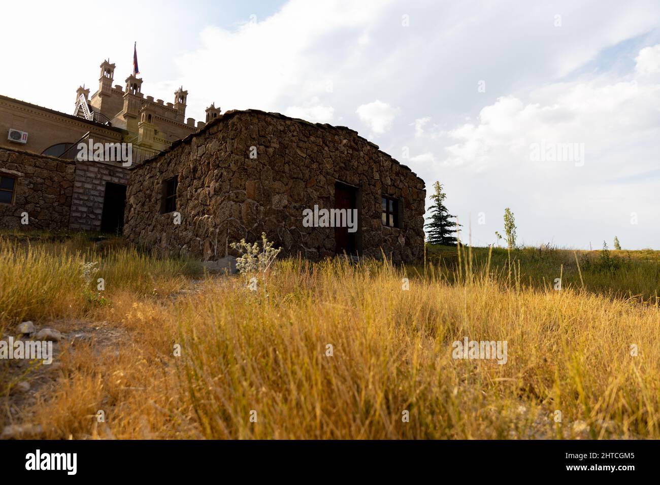 Single-storey building in the middle of the field with a private house ...
