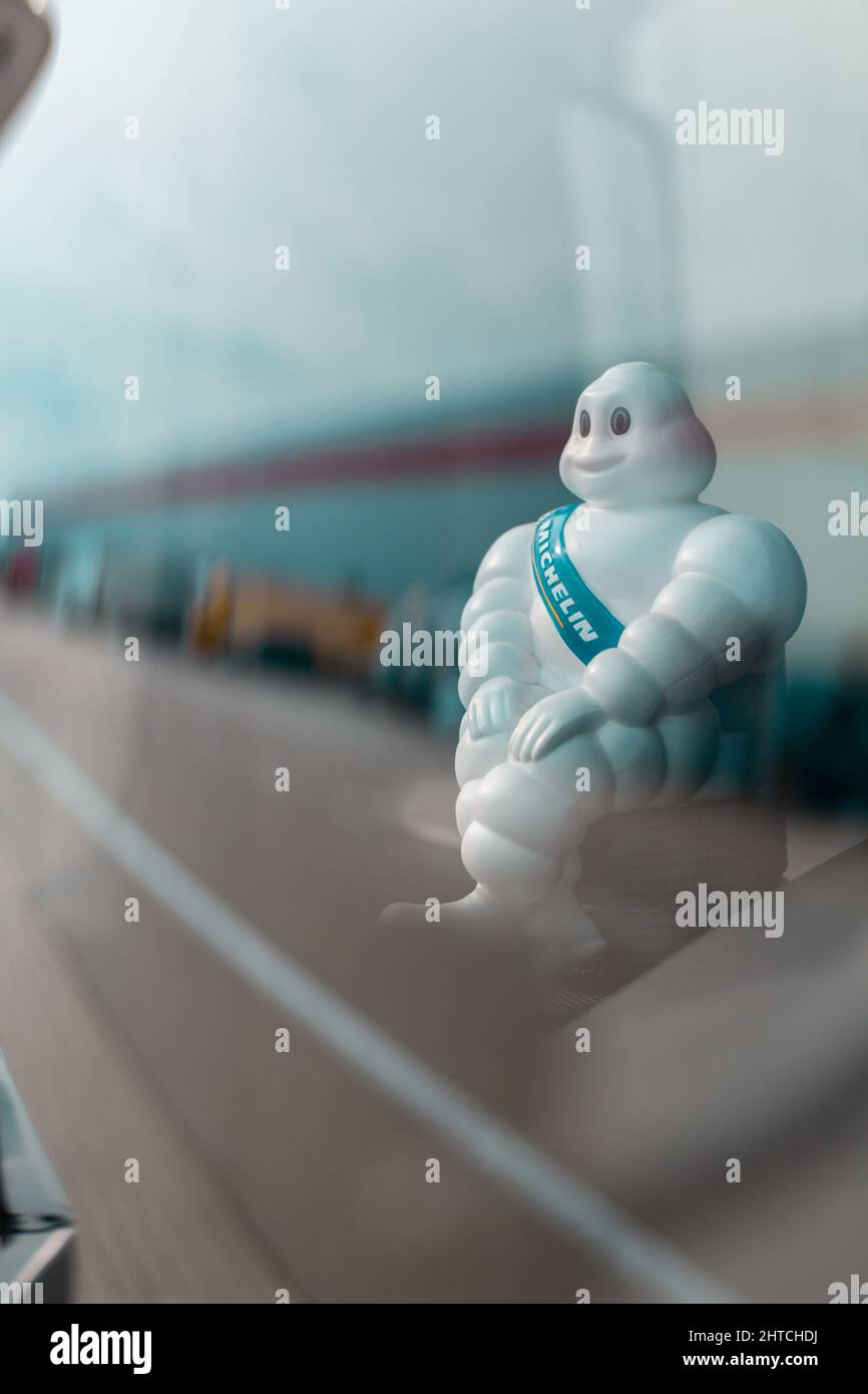 Michelin man sitting on a tire inside the vehicle Stock Photo - Alamy