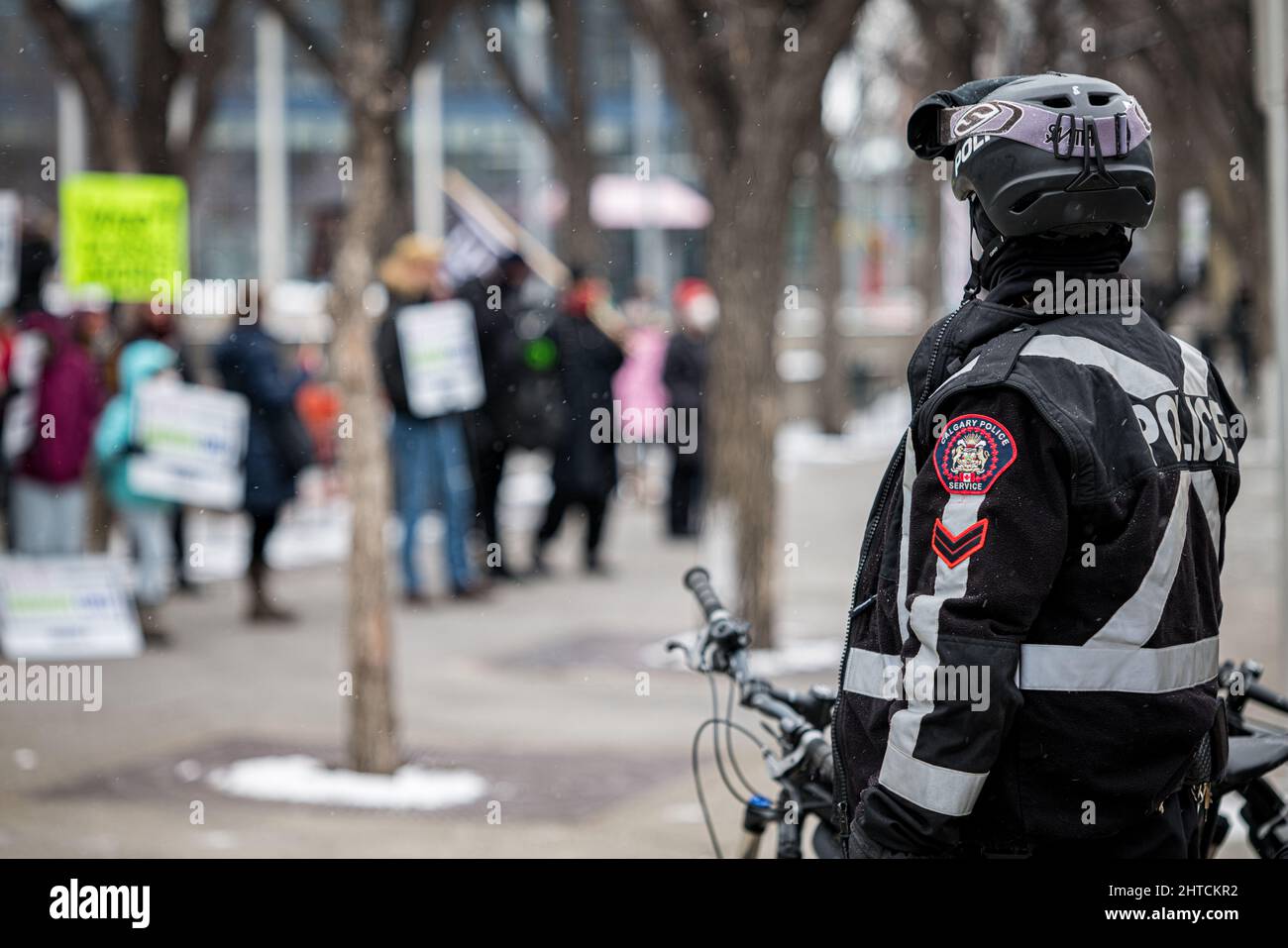 Police officer stands watch at a protest Stock Photo - Alamy