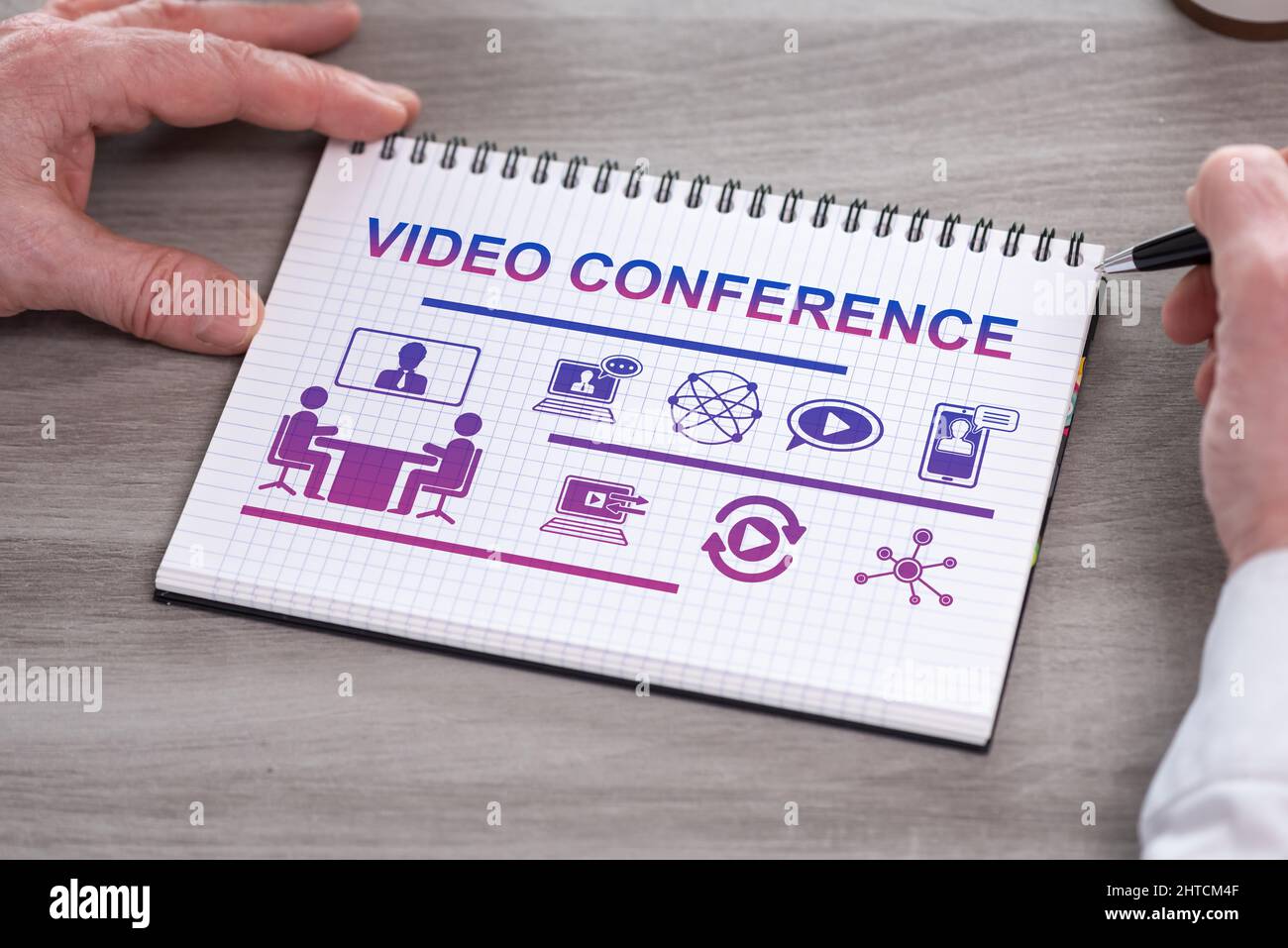 Hand holding a notepad with video conference concept Stock Photo - Alamy