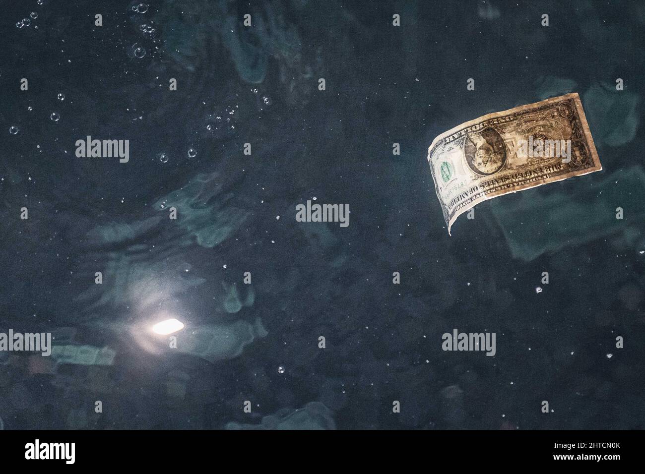 One dollar bill floating in water Stock Photo - Alamy