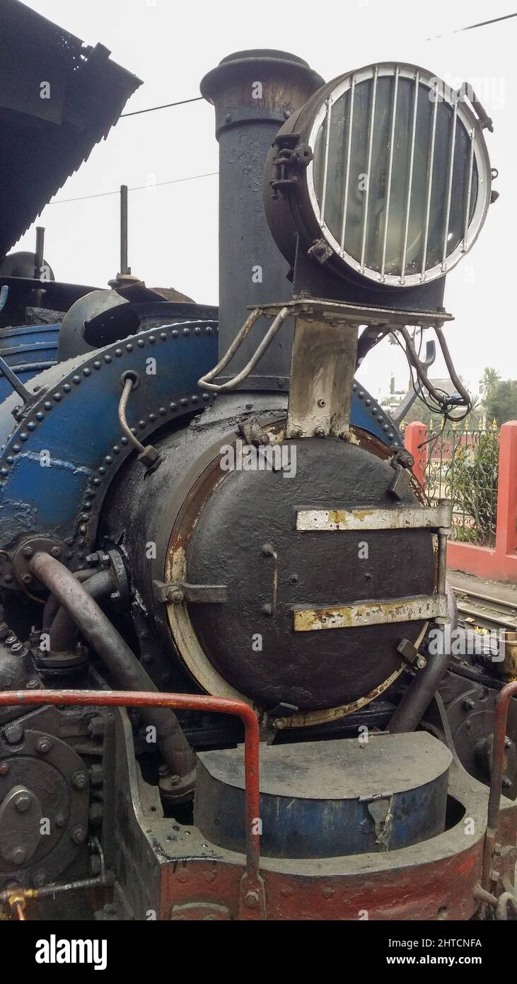 Vertical closeup of the front part of a rusted train in Ghum, India ...