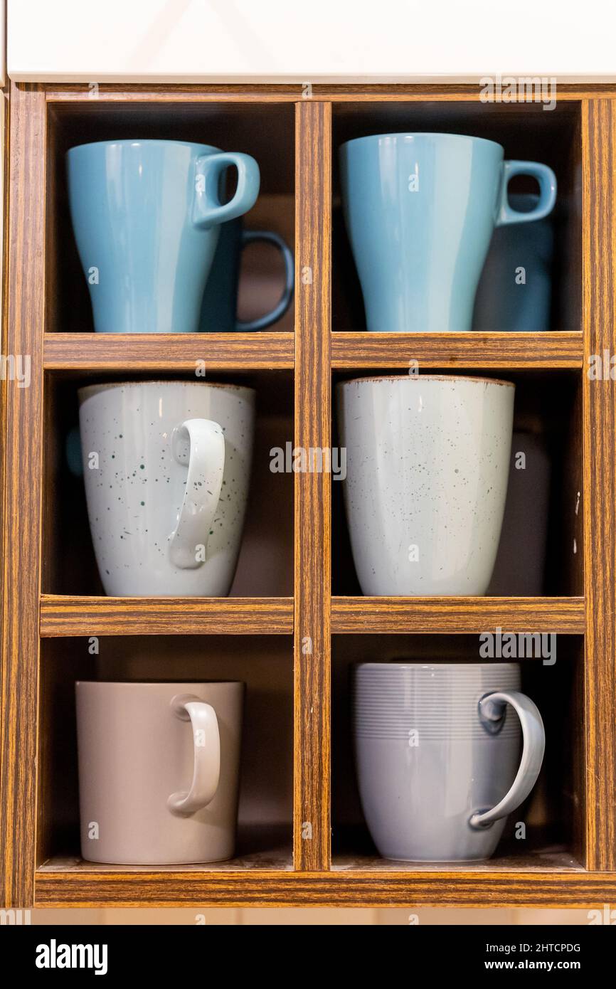 Cups on a shelf for cups Stock Photo - Alamy