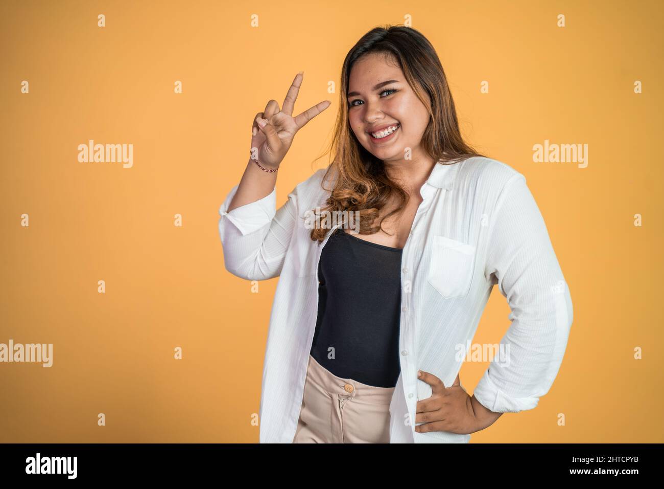 asian woman with cute hand gesture making v shape on finger Stock Photo ...