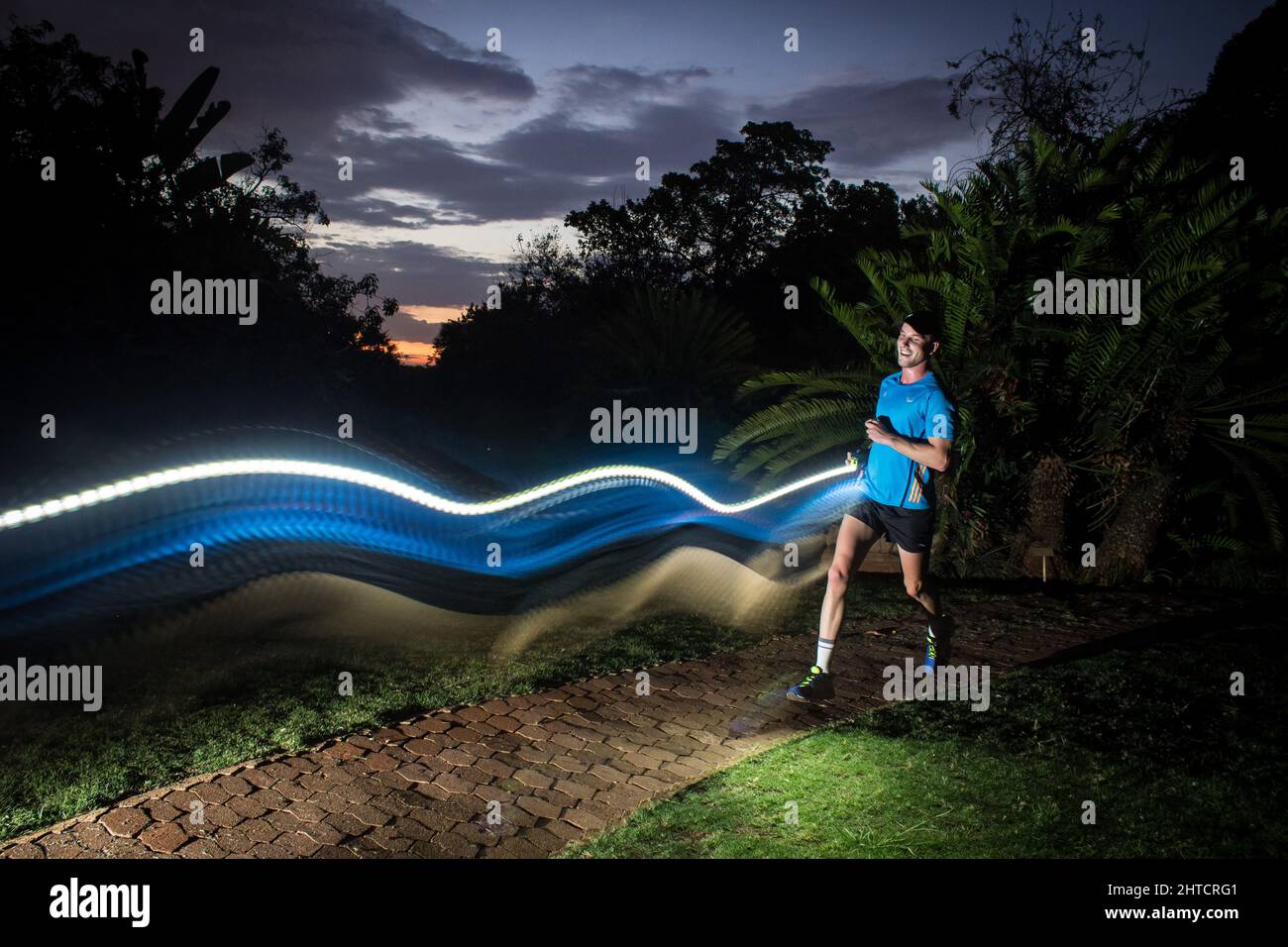 Trail runner running at night Stock Photo - Alamy