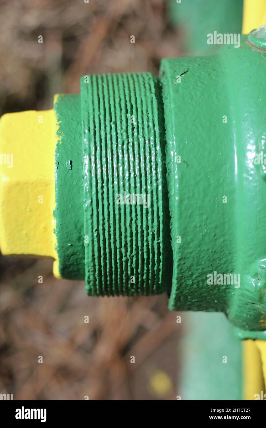 A rotating nut and bolt steel connection on an old tractor machine ...