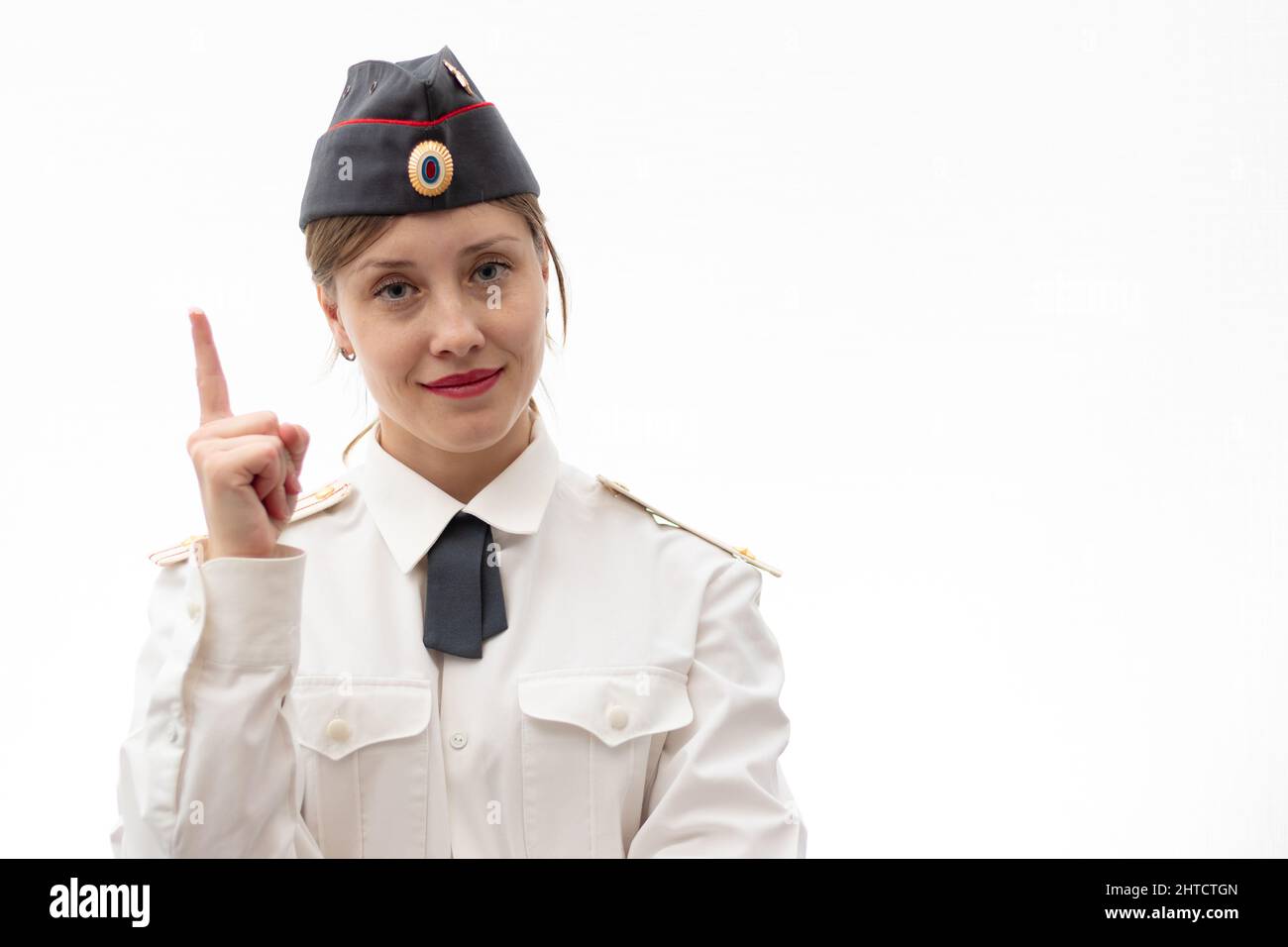 Beautiful young female Russian police officer in dress uniform shows ...
