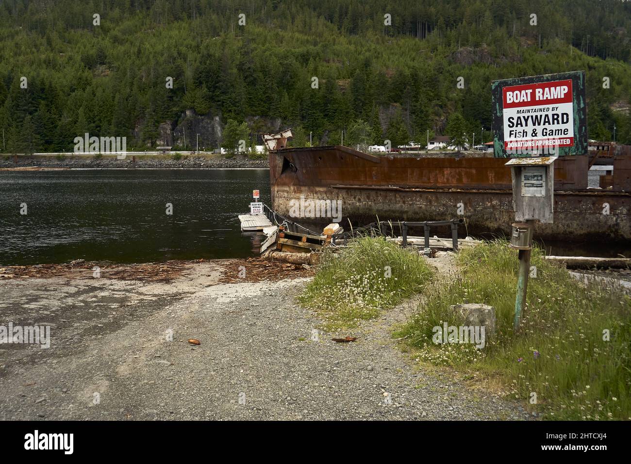 Sayward boat ramp and sign with old rusty navy corvette ship breakwater ...