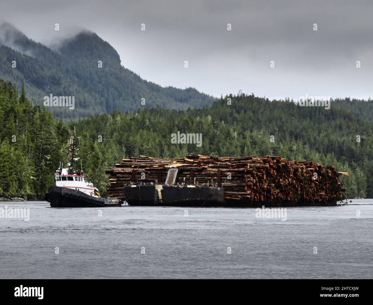 Large tug and log barge with barge on a short line waiting in Seymour ...