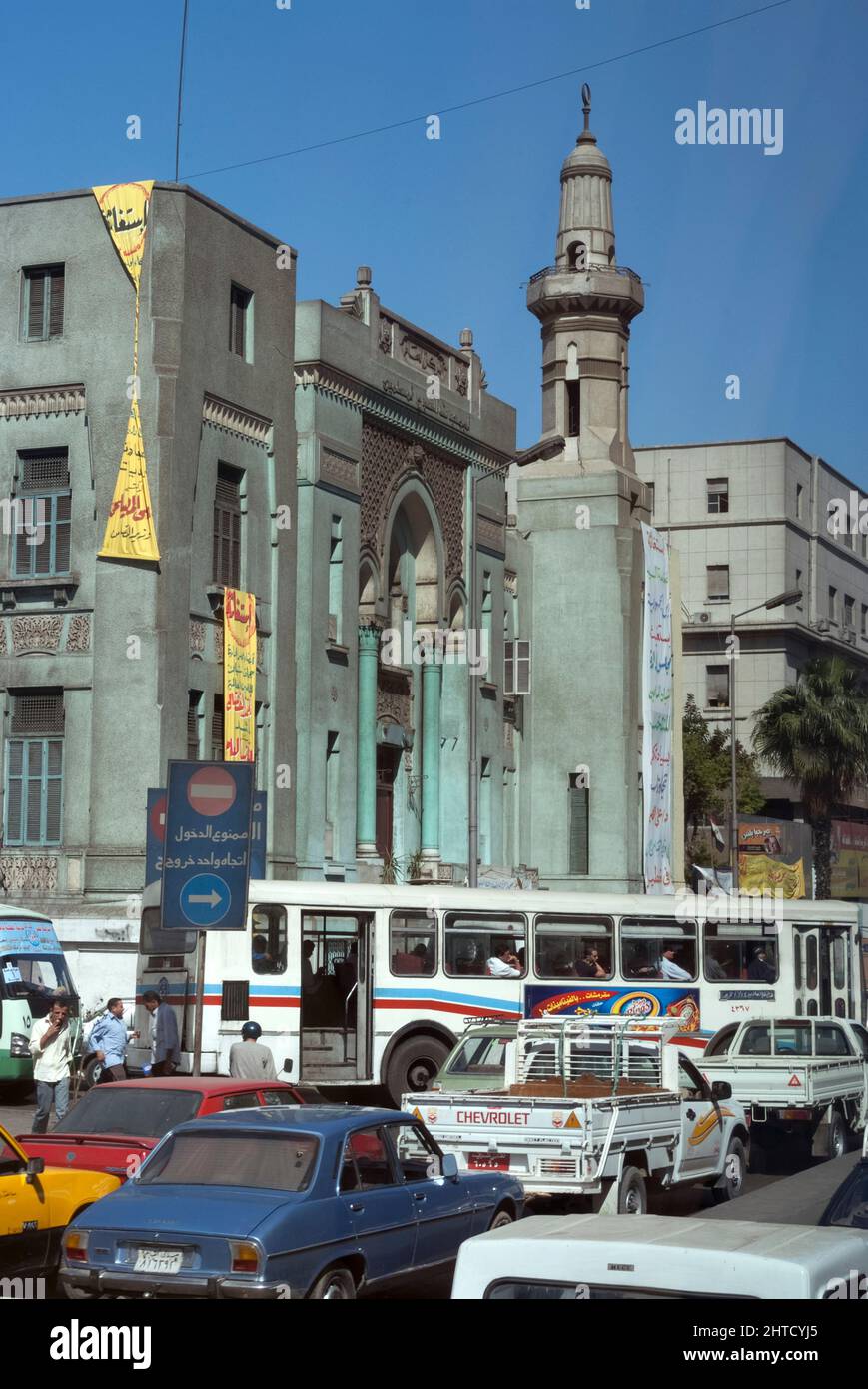 Cairo, Egypt, 2007. Busy street scene with a green mosque and minaret ...