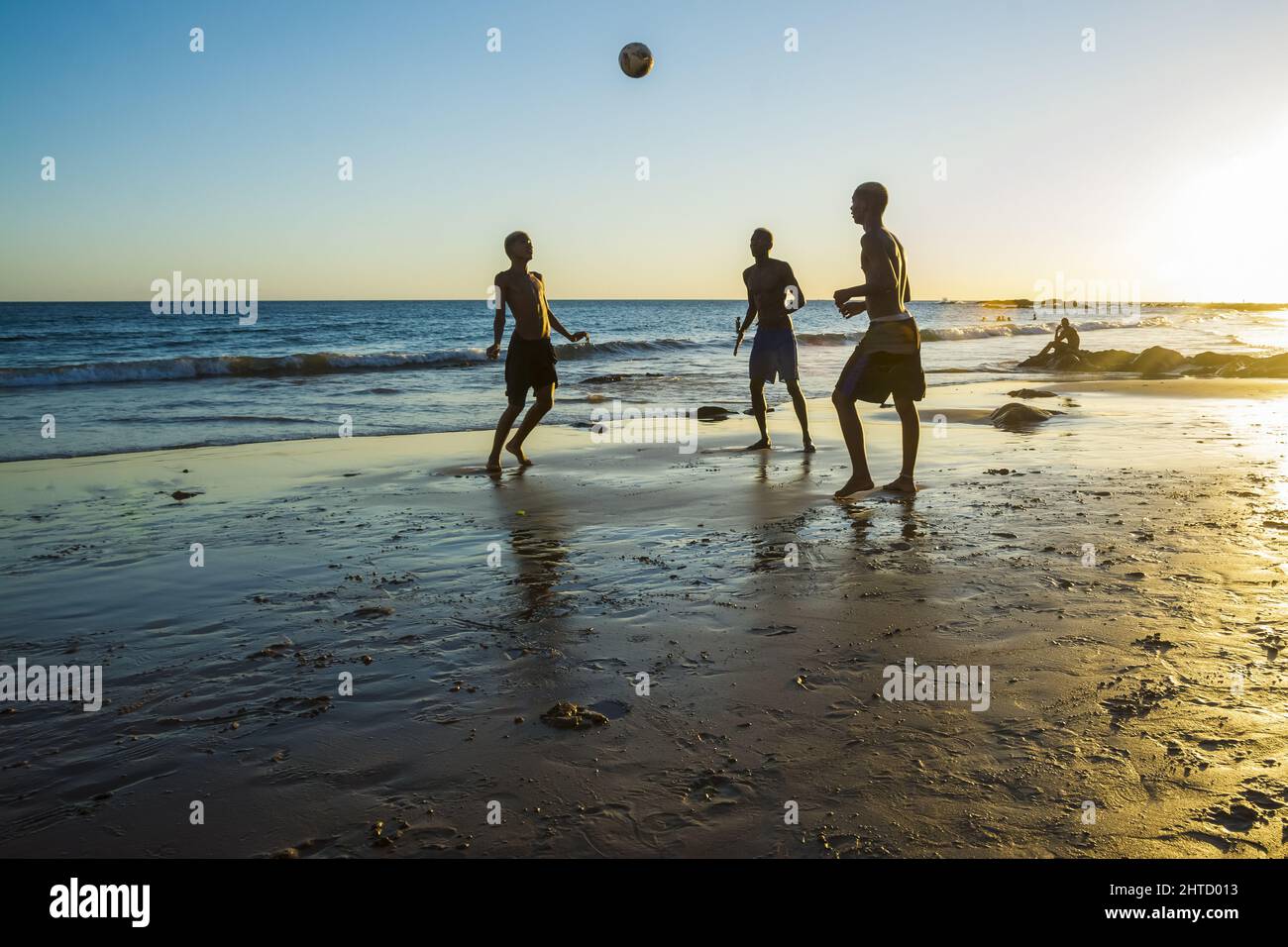 Young people playing sand football at sunset on Ondina beach in ...