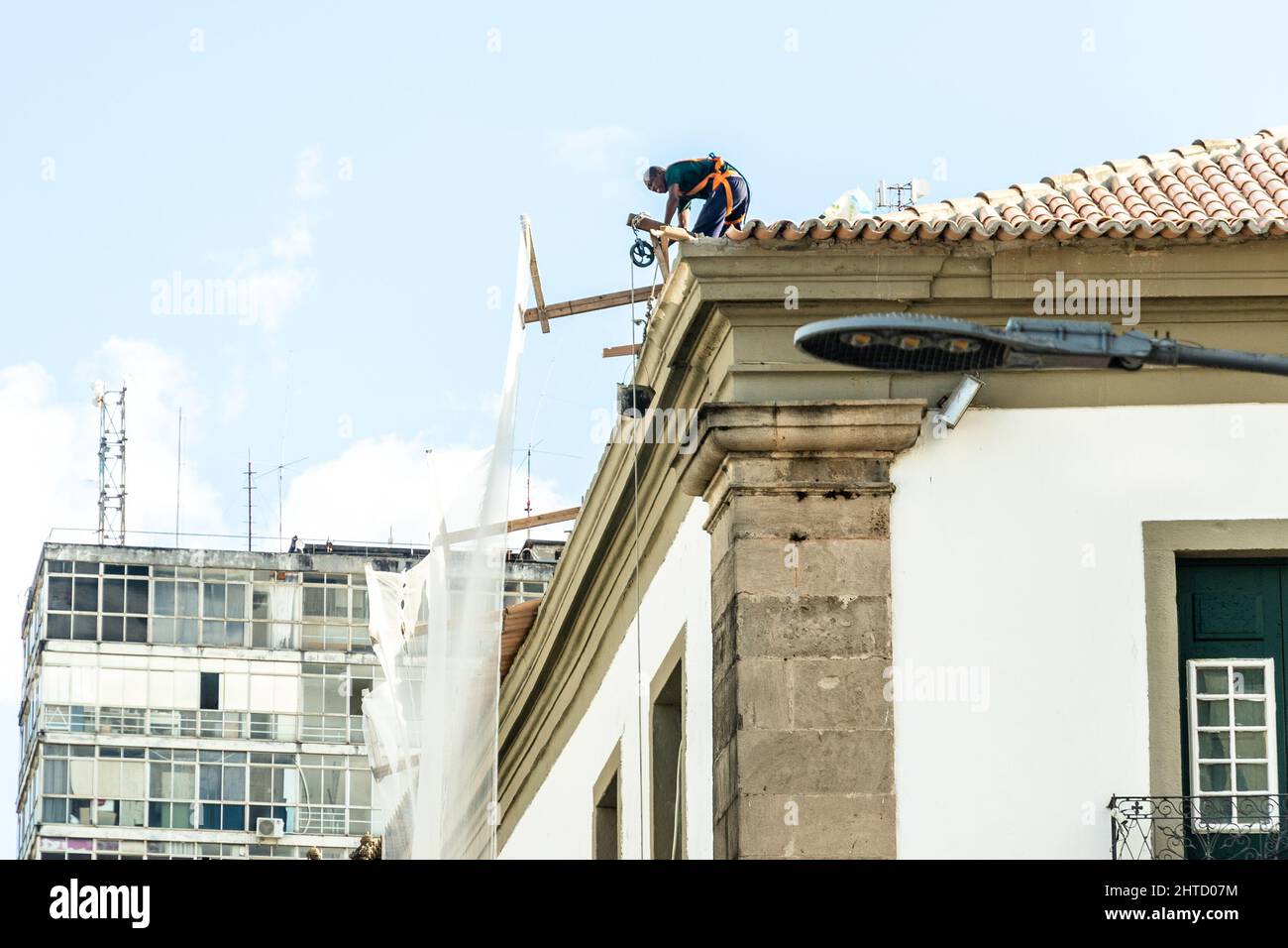 Construction worker on top of the roof repairing structure Stock Photo ...