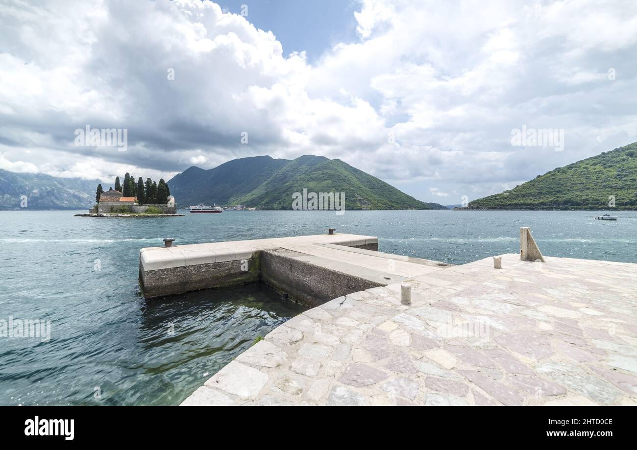 Landscape of Bay of Kotor with an island in the sea and a small stone ...