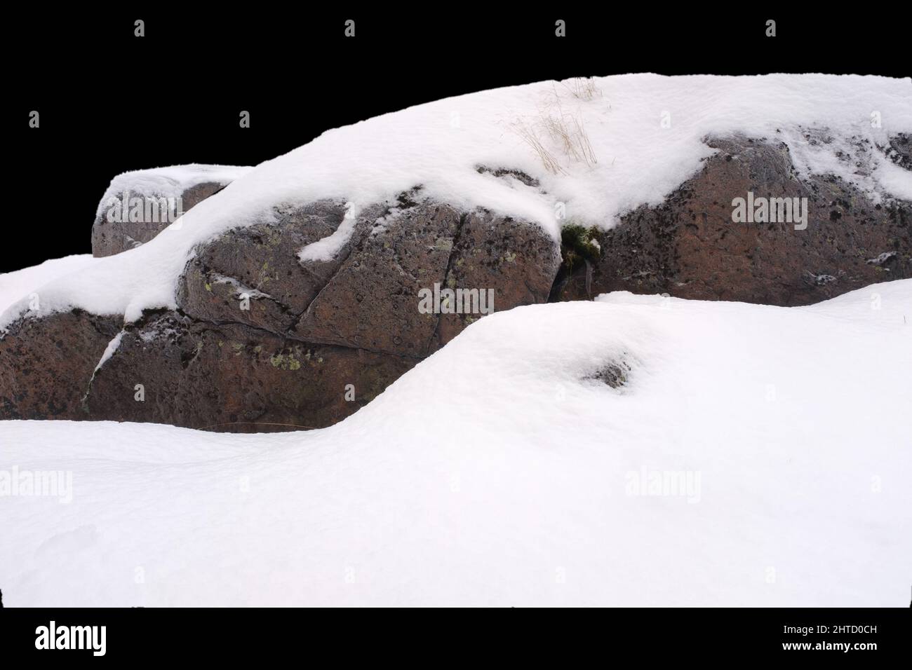 natural stone in snow isolated on black background. High quality photo ...