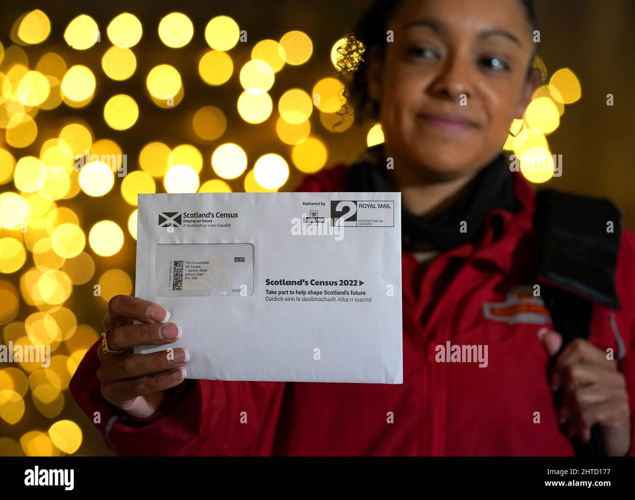 Postal worker Patrona Tunilla holds a sample Scotland's Census letter ...