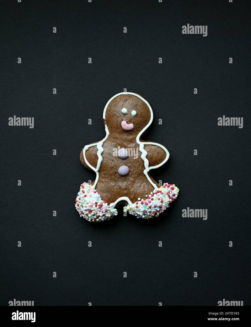 Vertical top view of a delicious gingerbread man cookie with frosting ...