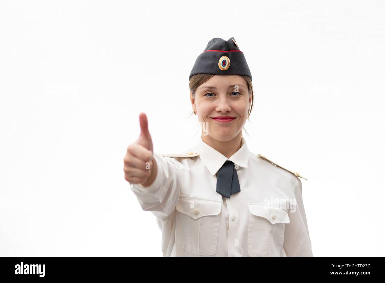 Beautiful young female Russian police officer in dress uniform shows ...