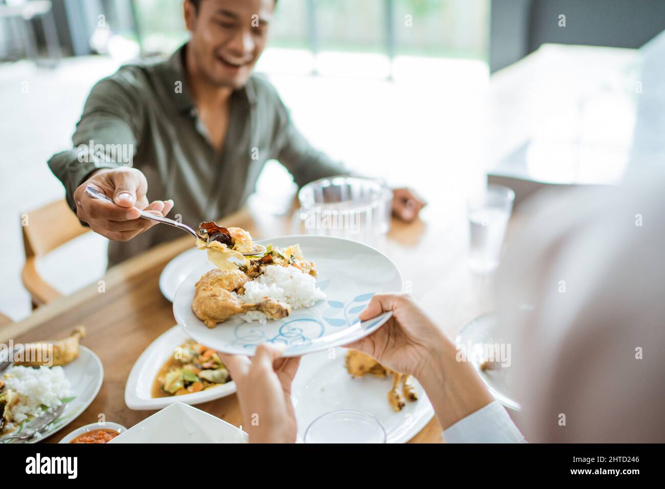 friends having fun eating lunch together at home with traditional food ...
