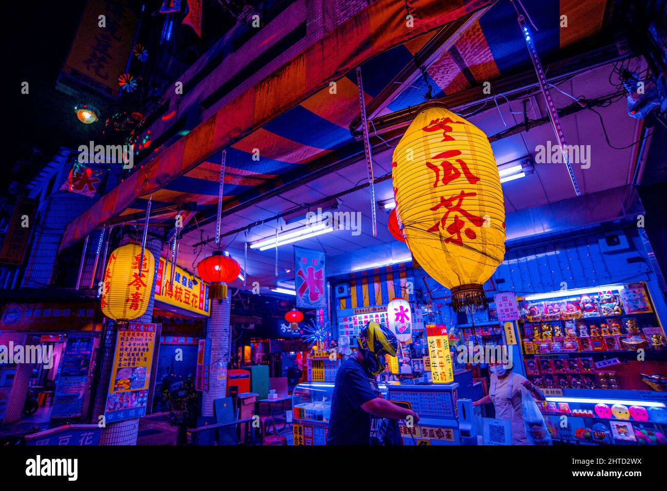 Beautiful storefront in Taiwan with bright neon blue lights shining ...