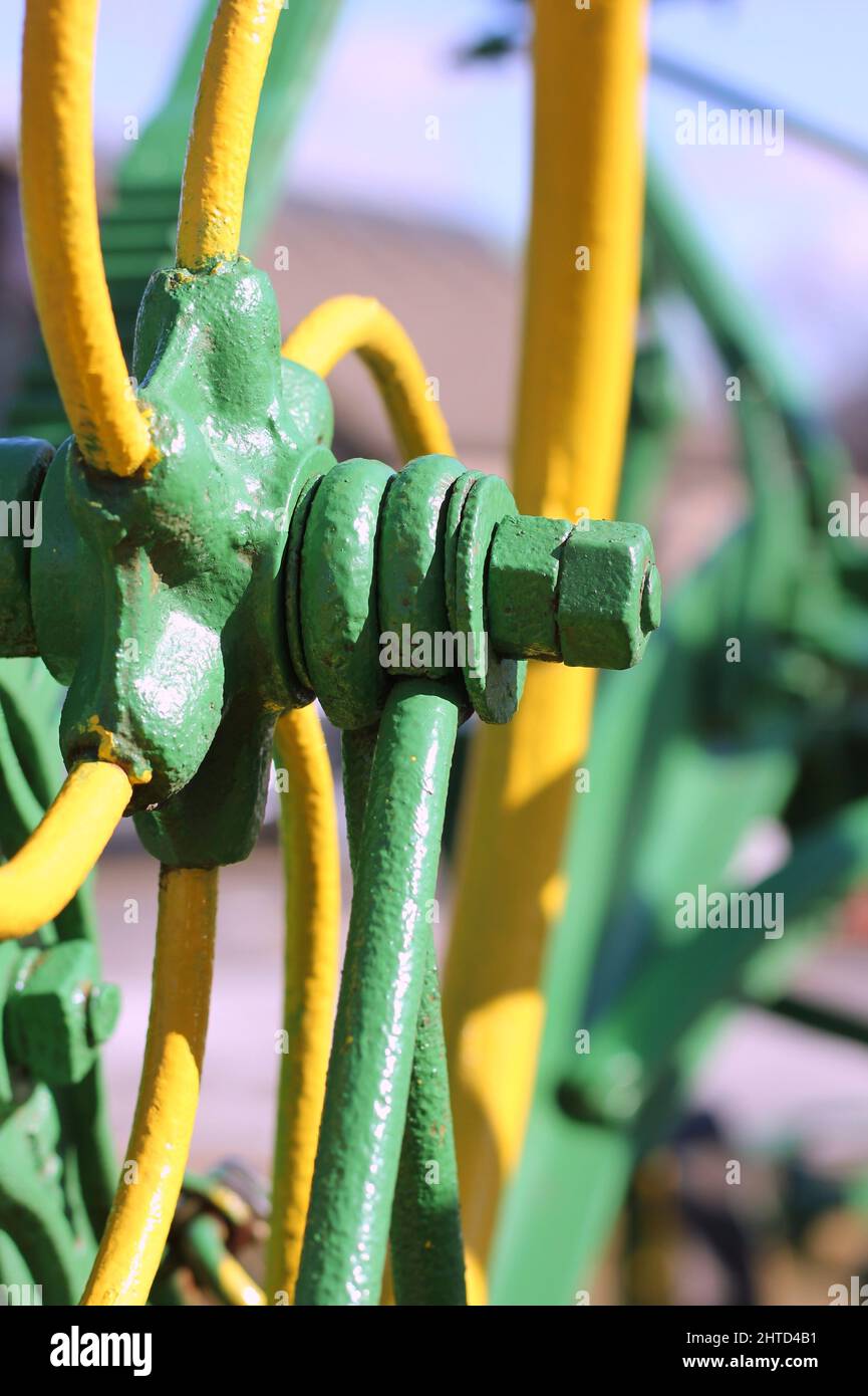 A rotating nut and bolt steel connection on an old tractor machine ...
