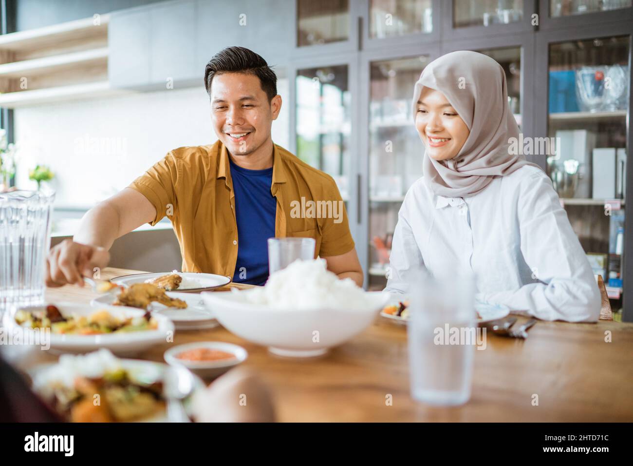 friends having fun eating lunch together at home with traditional food ...