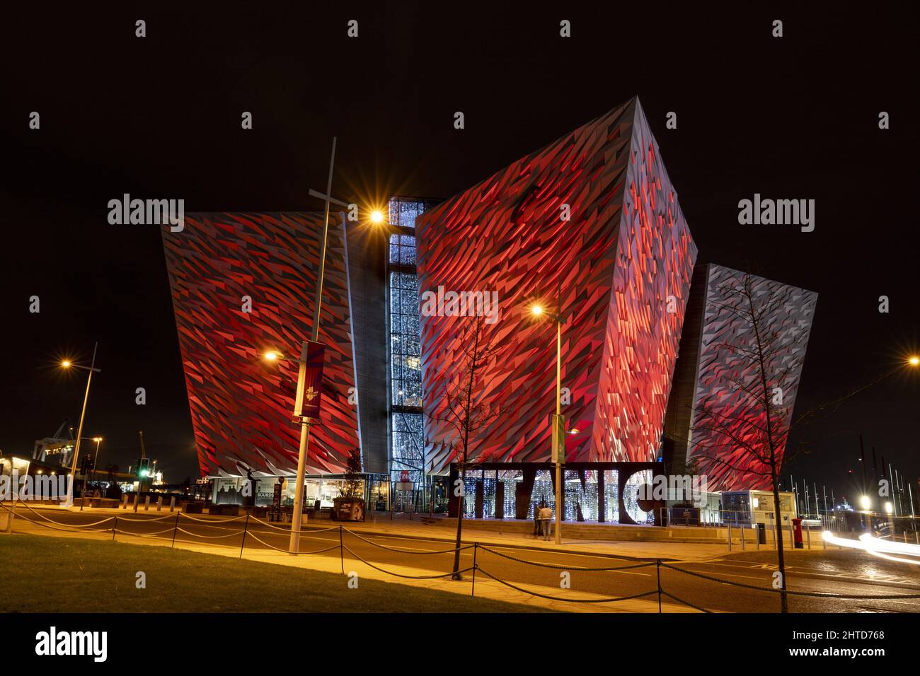 Beautiful view of the Titanic museum in Belfast lit up in red at night ...