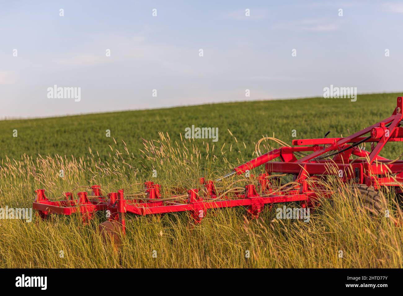 Metal red agricultural equipment against the background of the still ...
