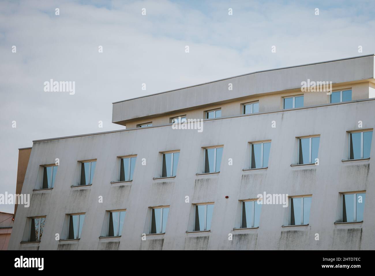 a shot of the windows of a big white building Stock Photo - Alamy