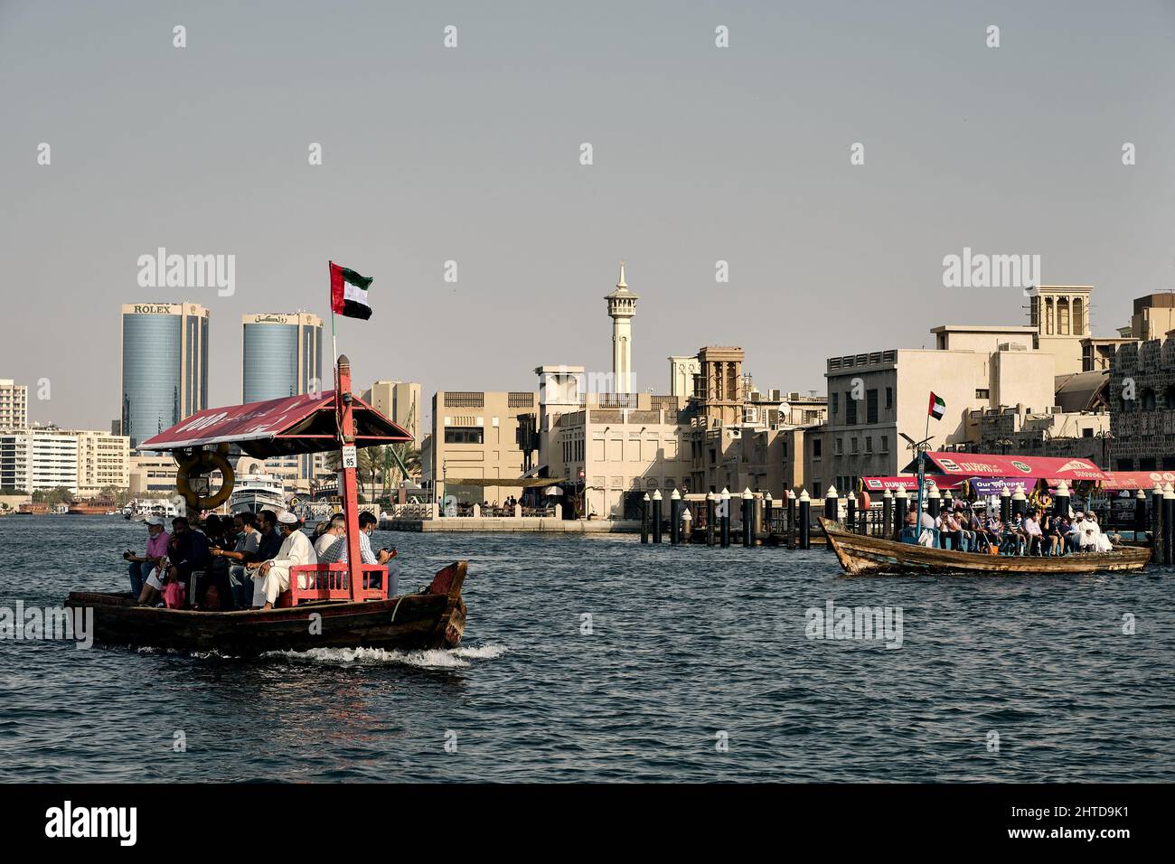 Group of tourists riding on an Abra boat crossing Dubai Creek Stock ...