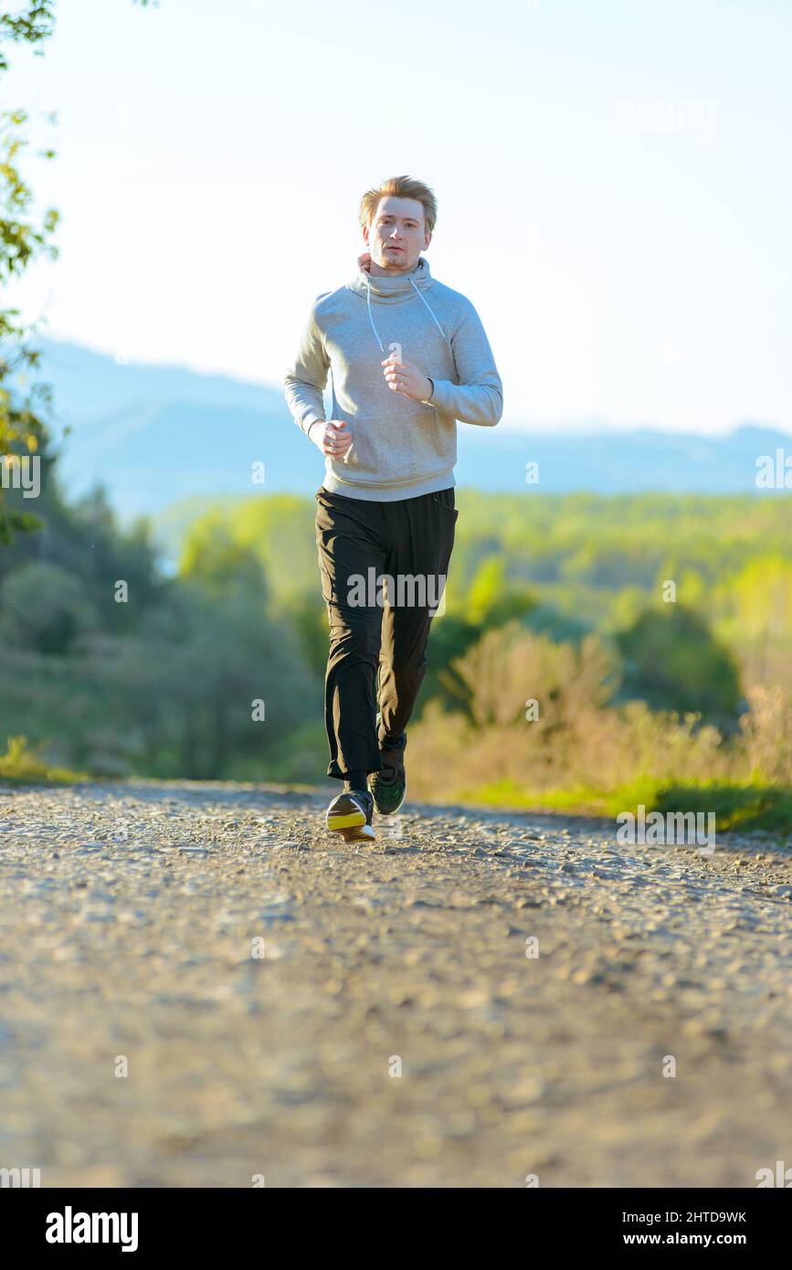 Running man jogging in rural nature at beautiful summer day. Sport ...