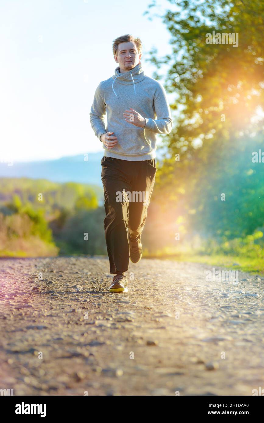 Running man jogging in rural nature at beautiful summer day. Sport ...