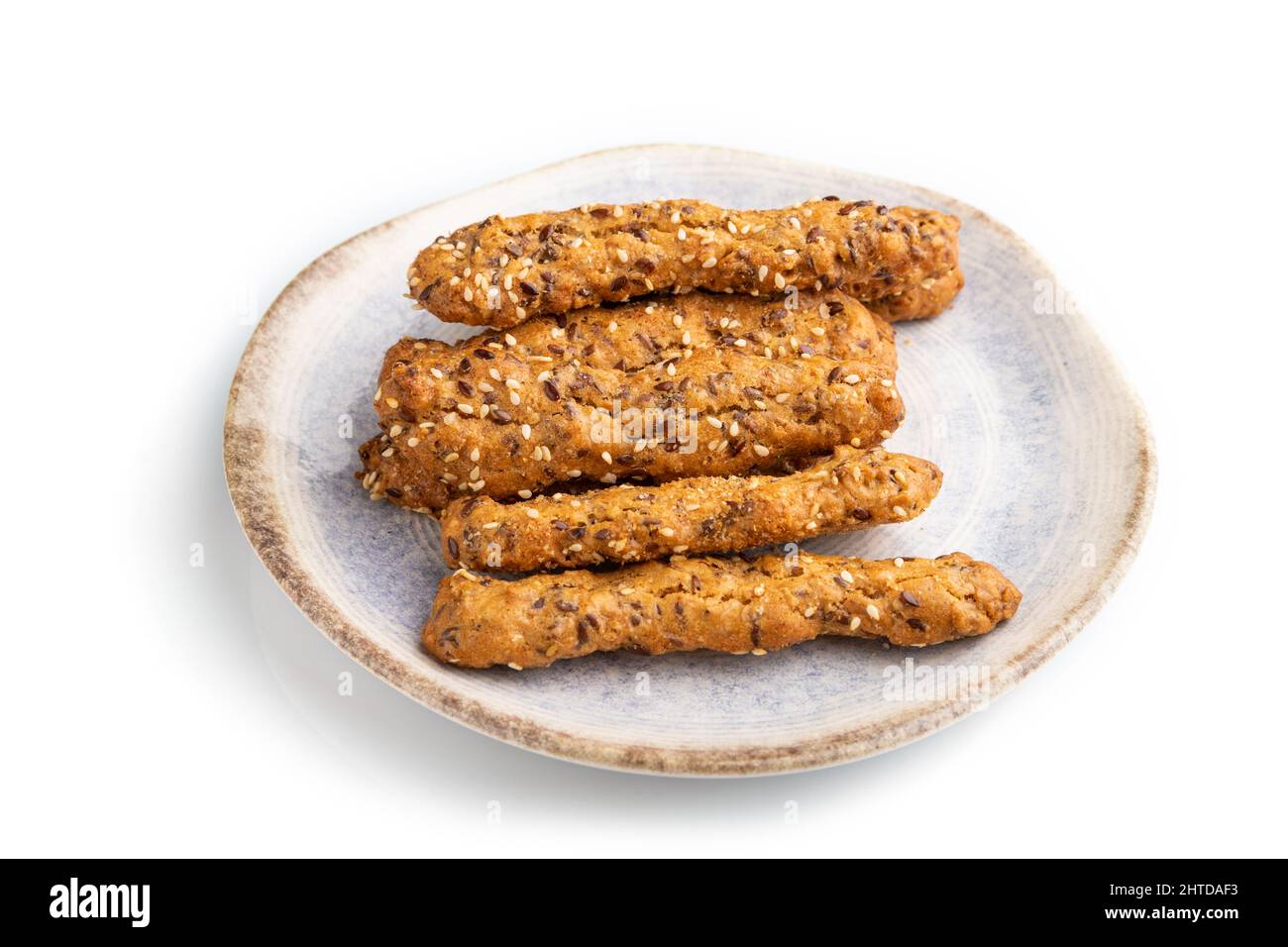 Crumble cookies with seasme and almonds on ceramic plate isolated on ...