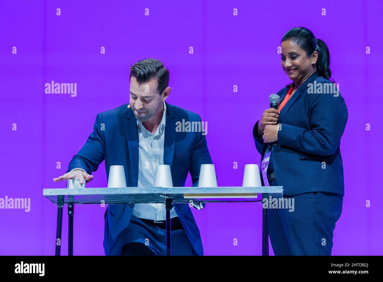 Celebrity Mentalist Gilan Gork on stage doing tricks with cups at Think ...