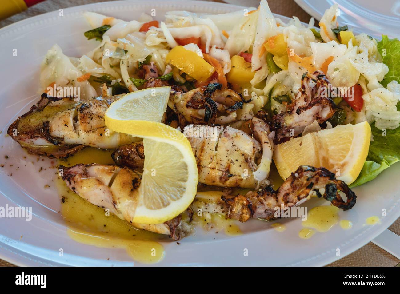 Grilled squids in restaurant on the island of Corfu, Ionian Islands ...