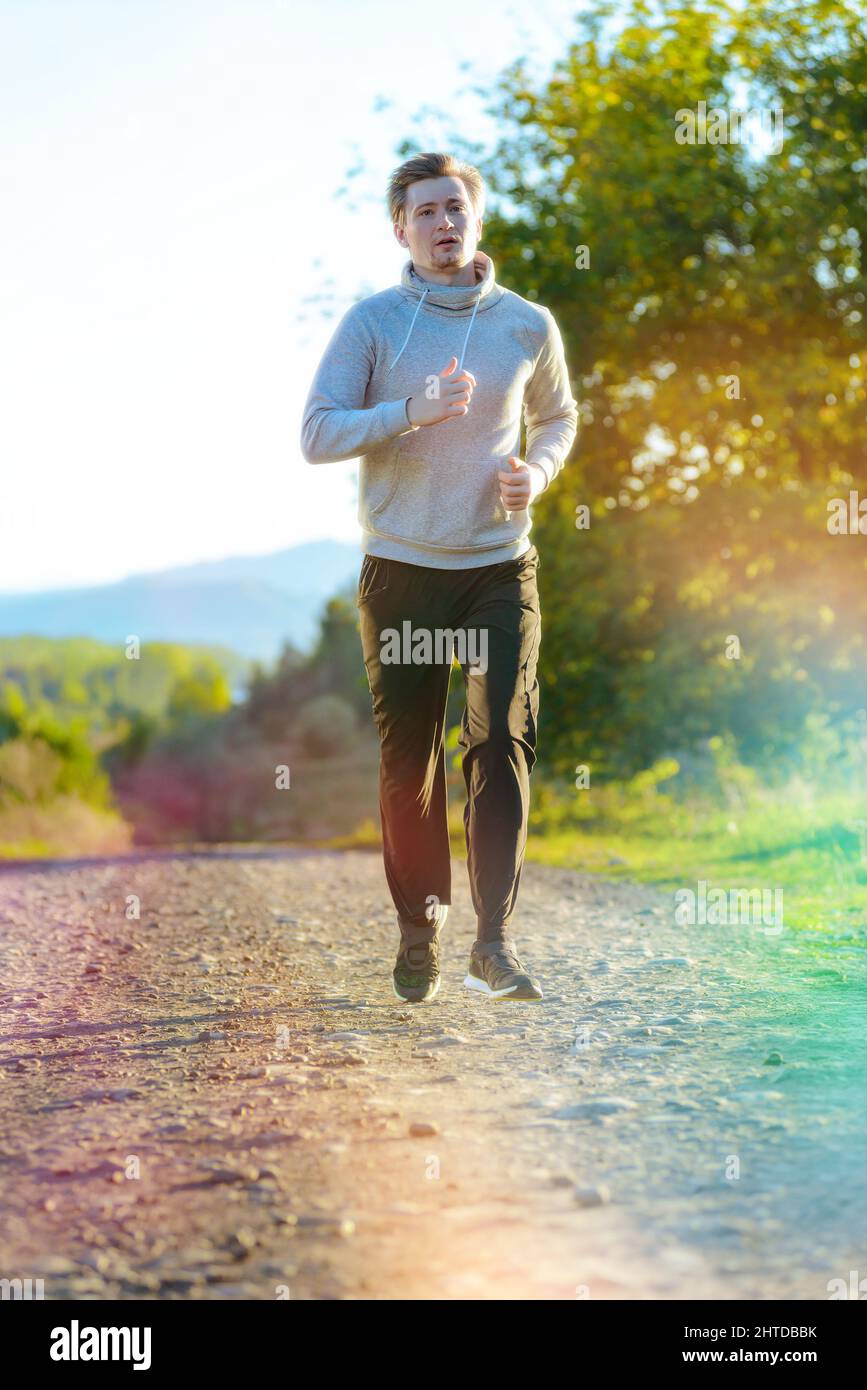Running man jogging in rural nature at beautiful summer day. Sport ...