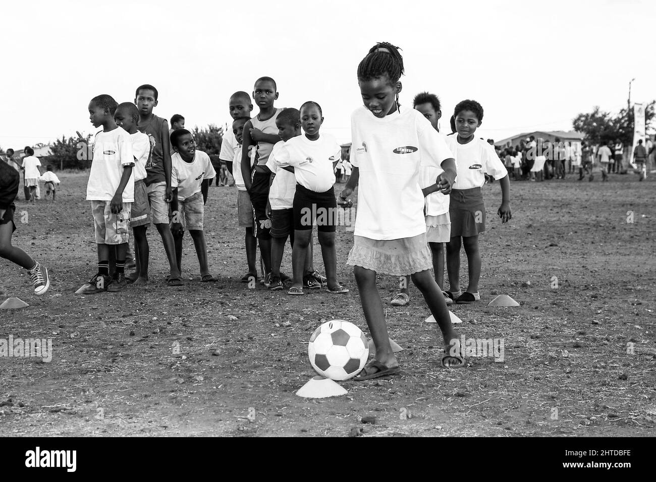 Gray scale picture of a group of African children playing with a ...