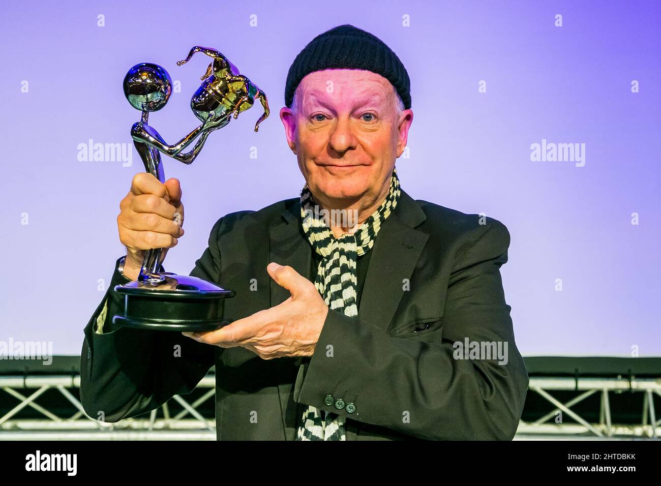 Pieter Dirk Uys holding his lifetime achievement award at Comics Choice ...