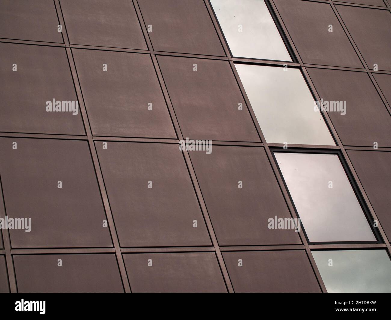 Exterior of a building with square glass windows Stock Photo - Alamy