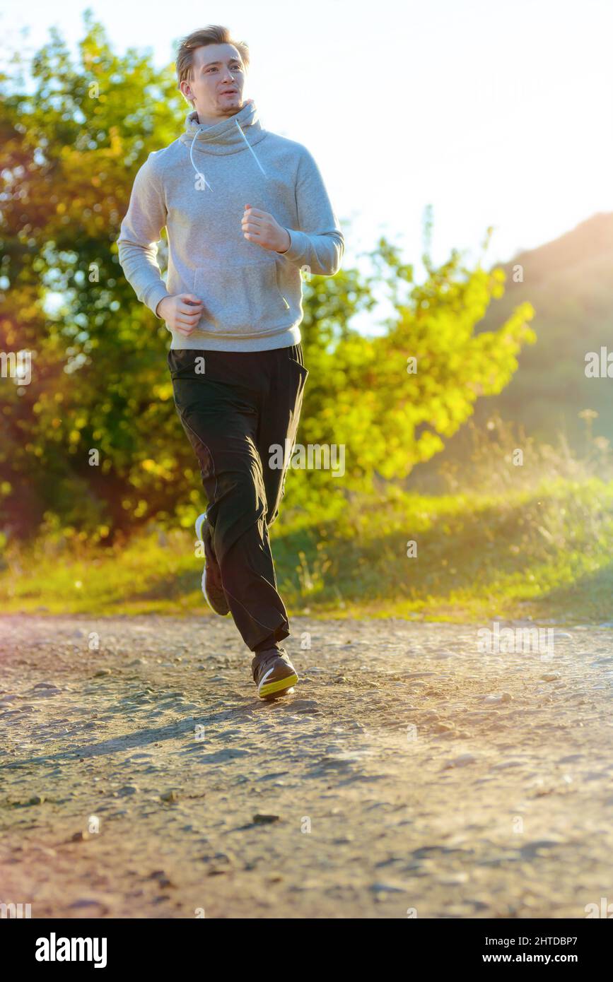 Running man jogging in rural nature at beautiful summer day. Sport ...