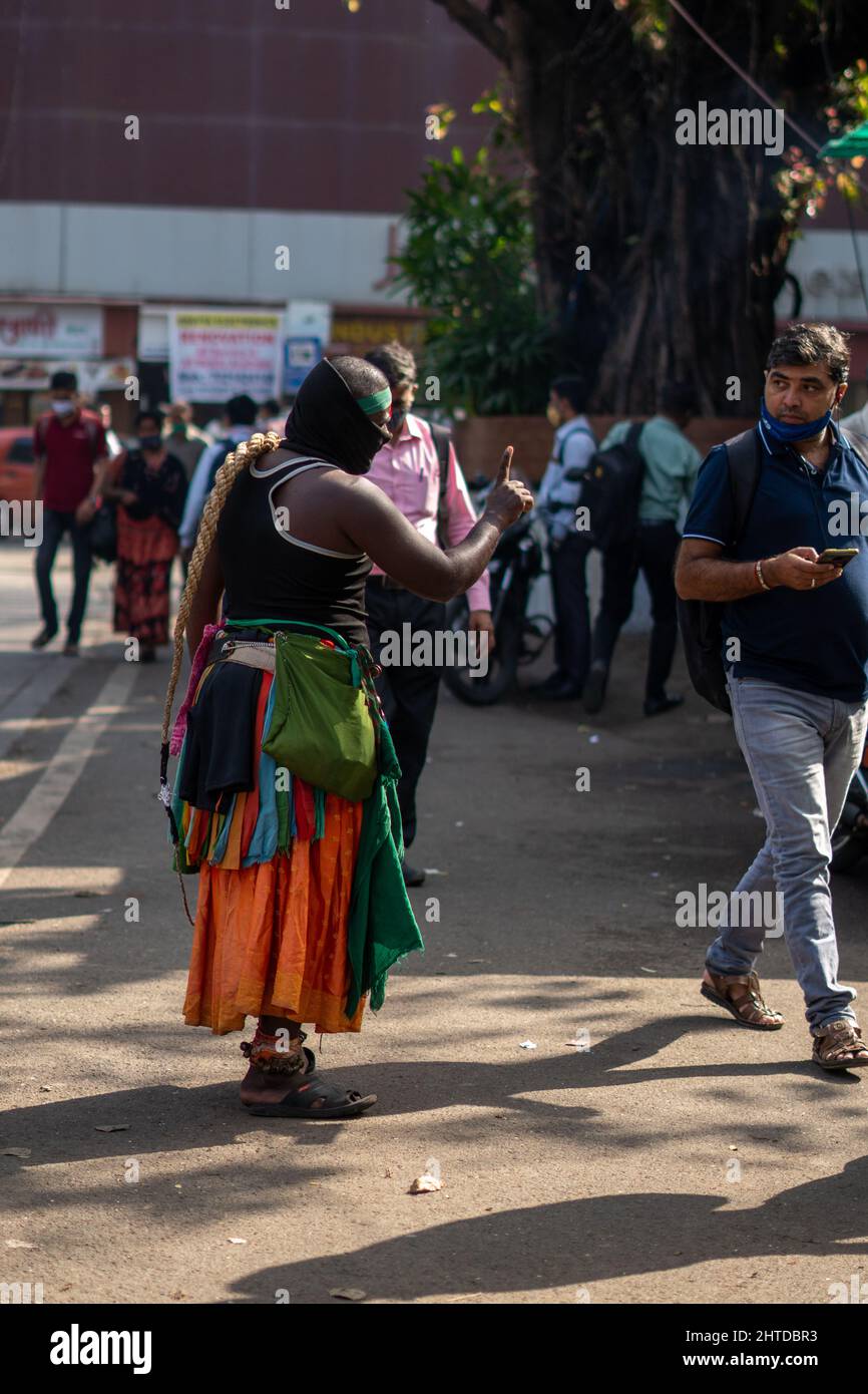 Vertical shot of street performer artists whipping baba Patta wala ...
