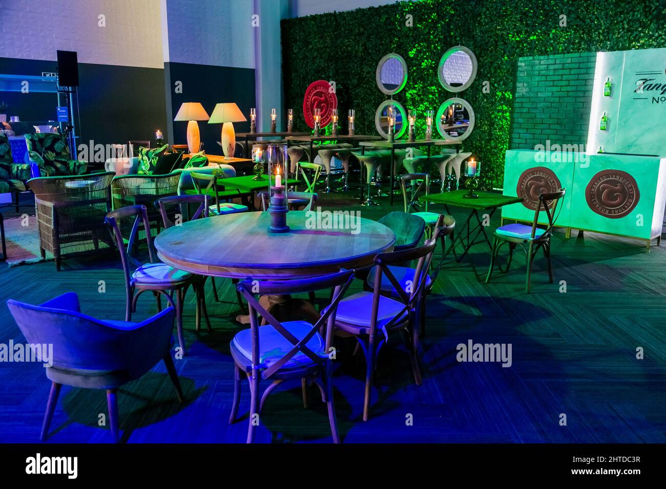 Interior of a Tanqueray branded decor with blue and green lightenings ...